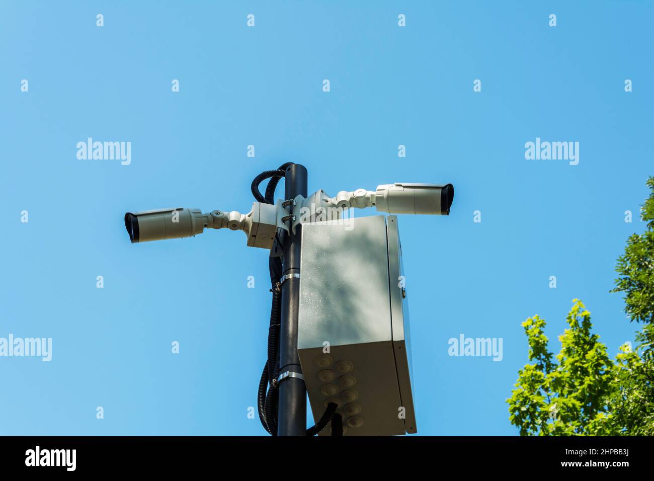 Security cameras and a Wi-Fi station installed on a pole in a public ...
