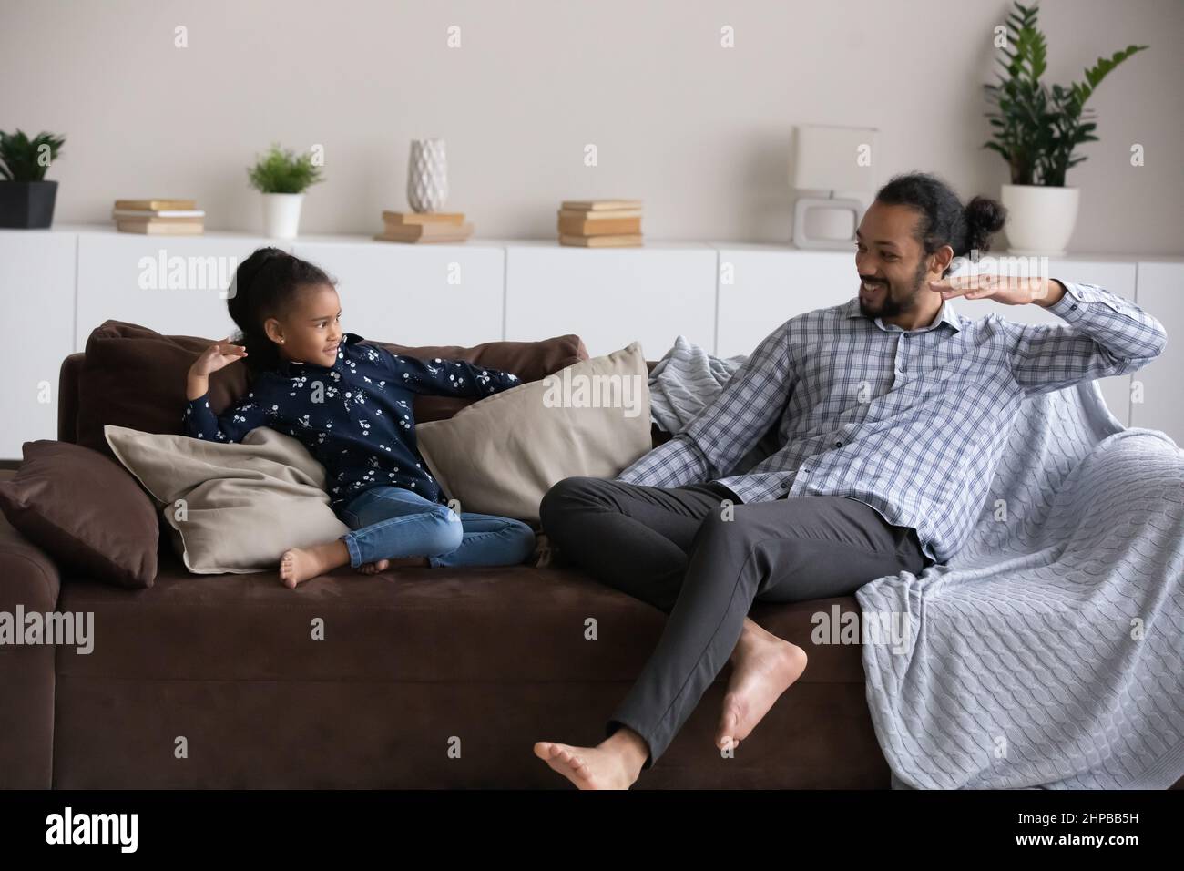 Happy little cute African American kid talking with dad Stock Photo - Alamy