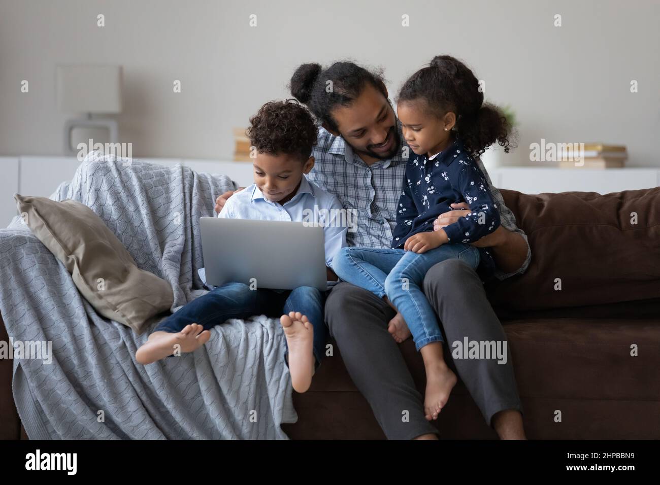 Happy African American family using computer at home Stock Photo - Alamy