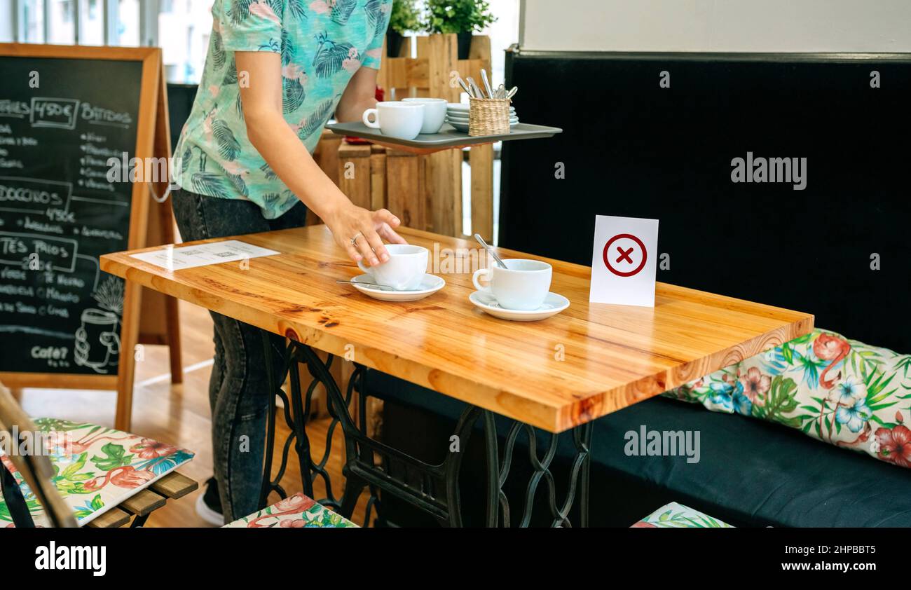 Unrecognizable woman disinfecting table hi-res stock photography and ...