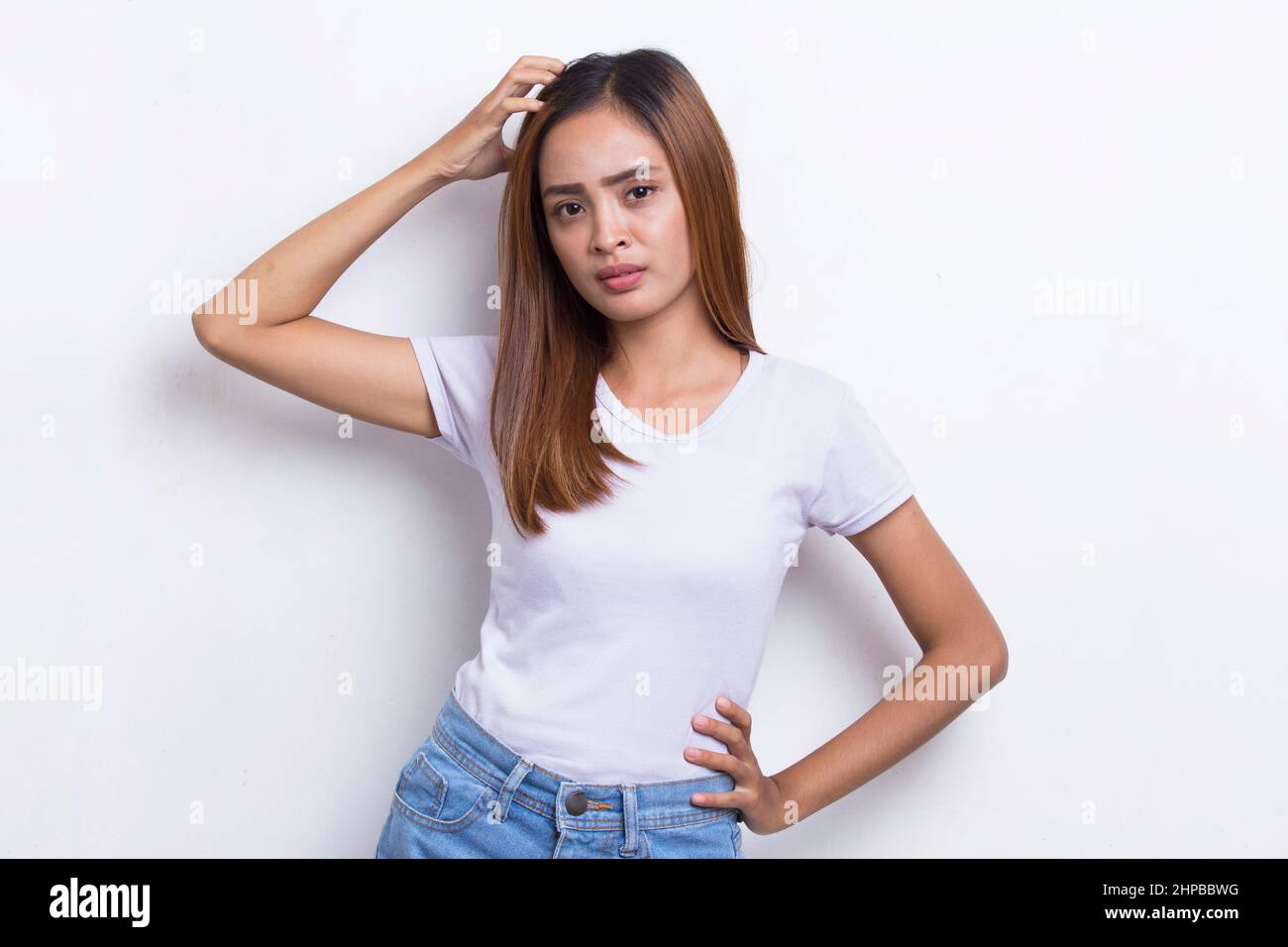 Young beautiful asian woman scratching head with hand isolated on white ...