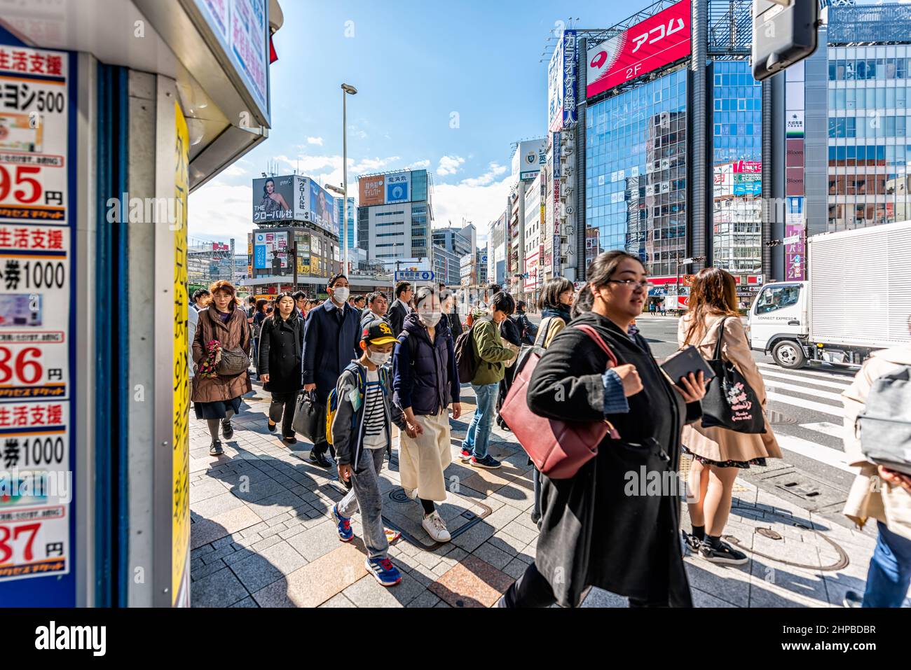Tokyo, Japan - March 31, 2019: Shinjuku sidewalk street road with busy ...