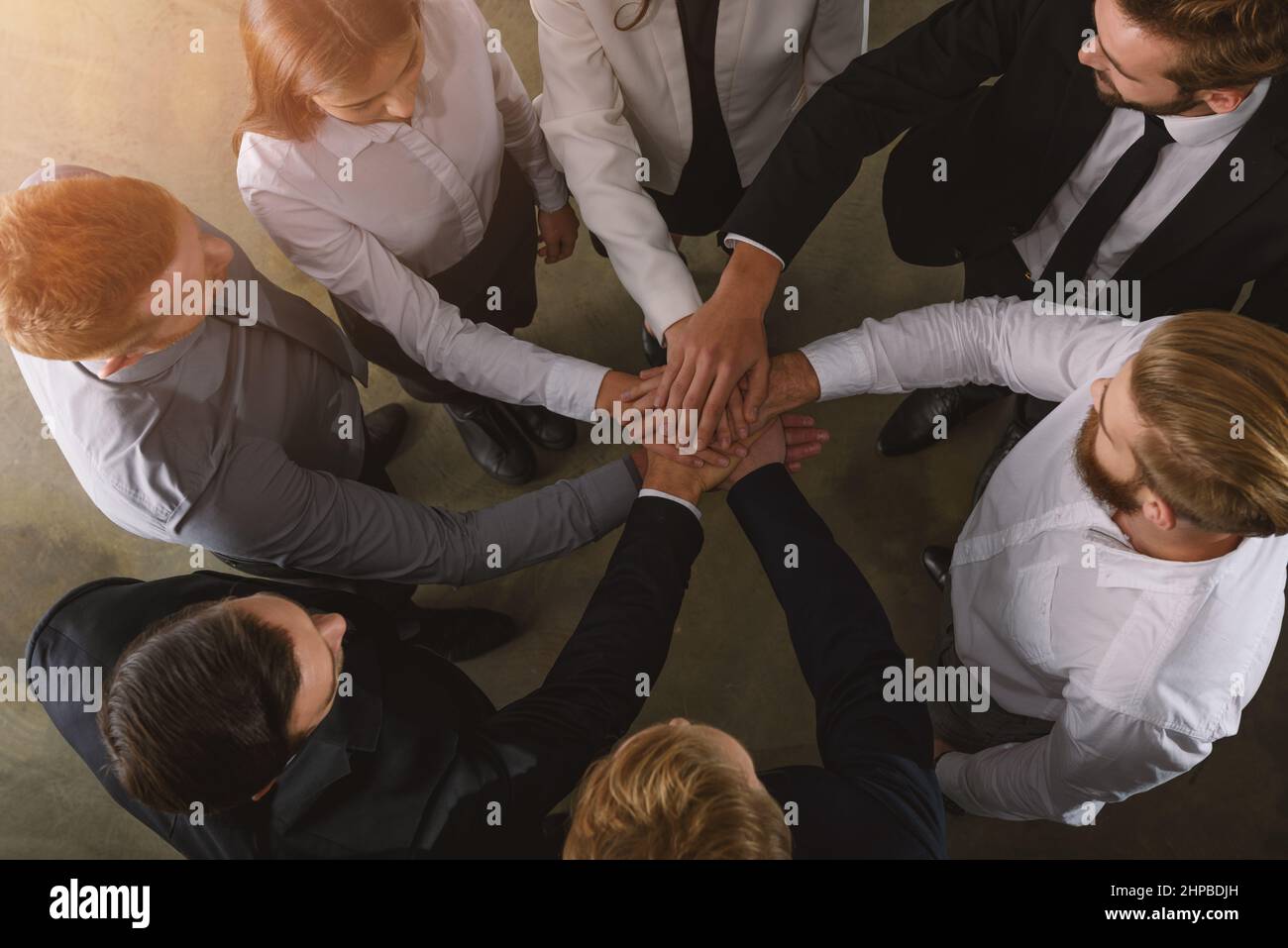 Business people putting their hands together as teamwork and partner ...