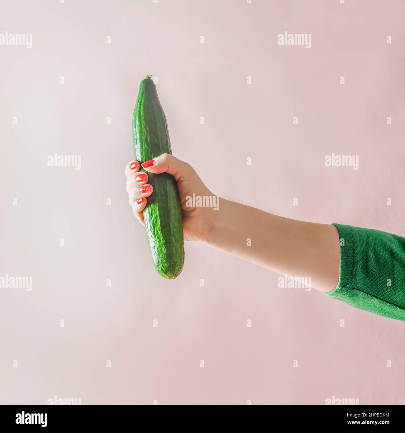 Hand holding cucumber hi-res stock photography and images - Alamy