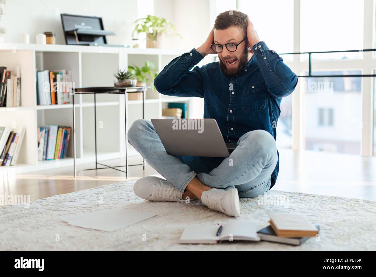 Shocked Man Looking At Laptop Shouting Sitting On Floor Indoor Stock ...