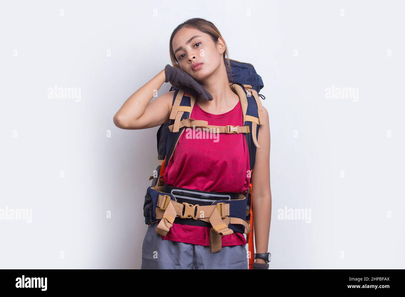 Young beautiful hiker asian woman with a backpack feeling tired ...