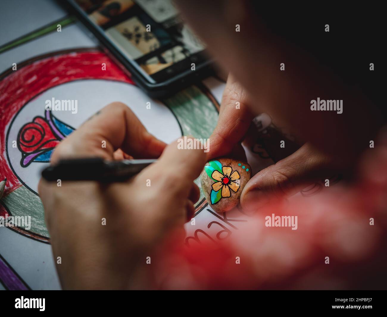 Person coloring an object using special tool and vibrant paint colors ...