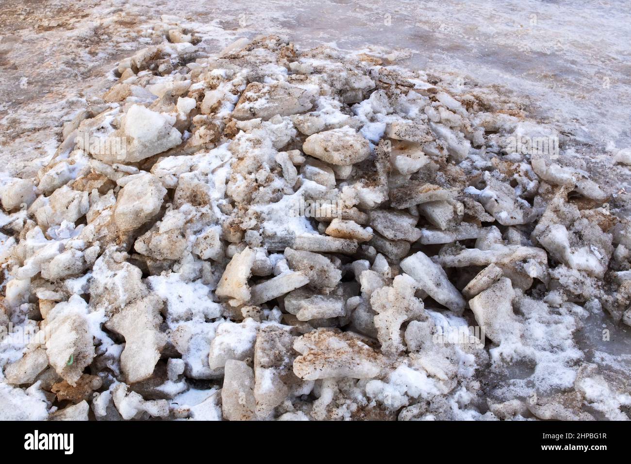 Pile of pieces of dirty ice on the sidewalk close up Stock Photo - Alamy