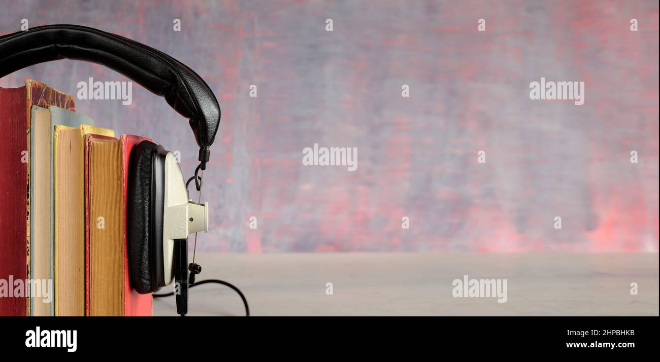 audio book concept with stack of books, and vintage headphones, close ...