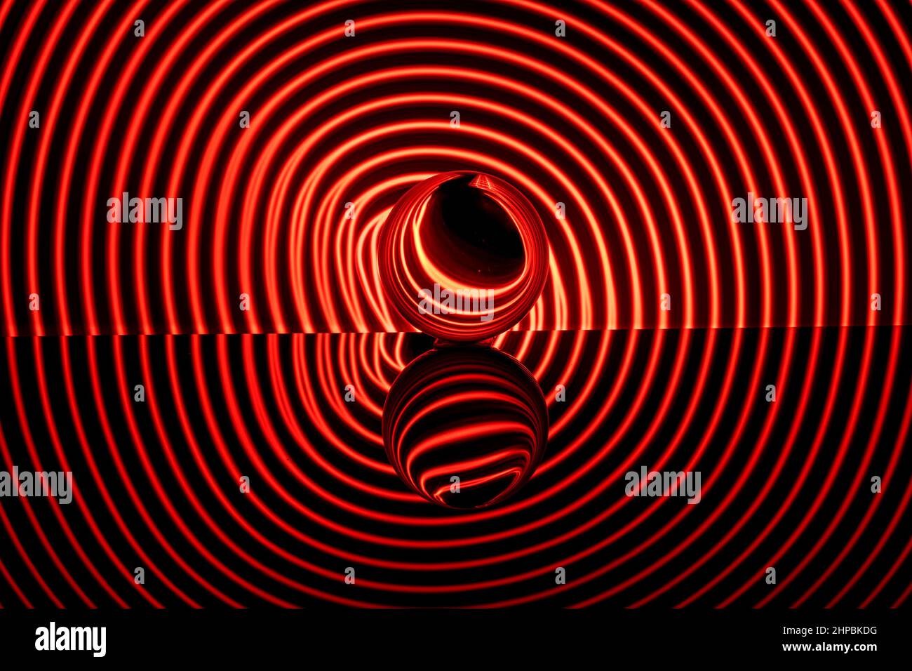 red glowing circles around a glass ball Stock Photo - Alamy