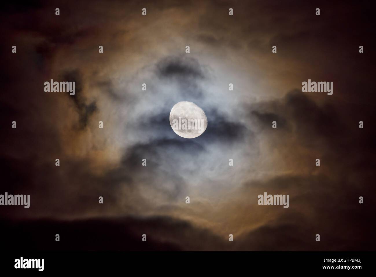 Mystery spooky moon shining through a clouds, glowing colorful moon ...