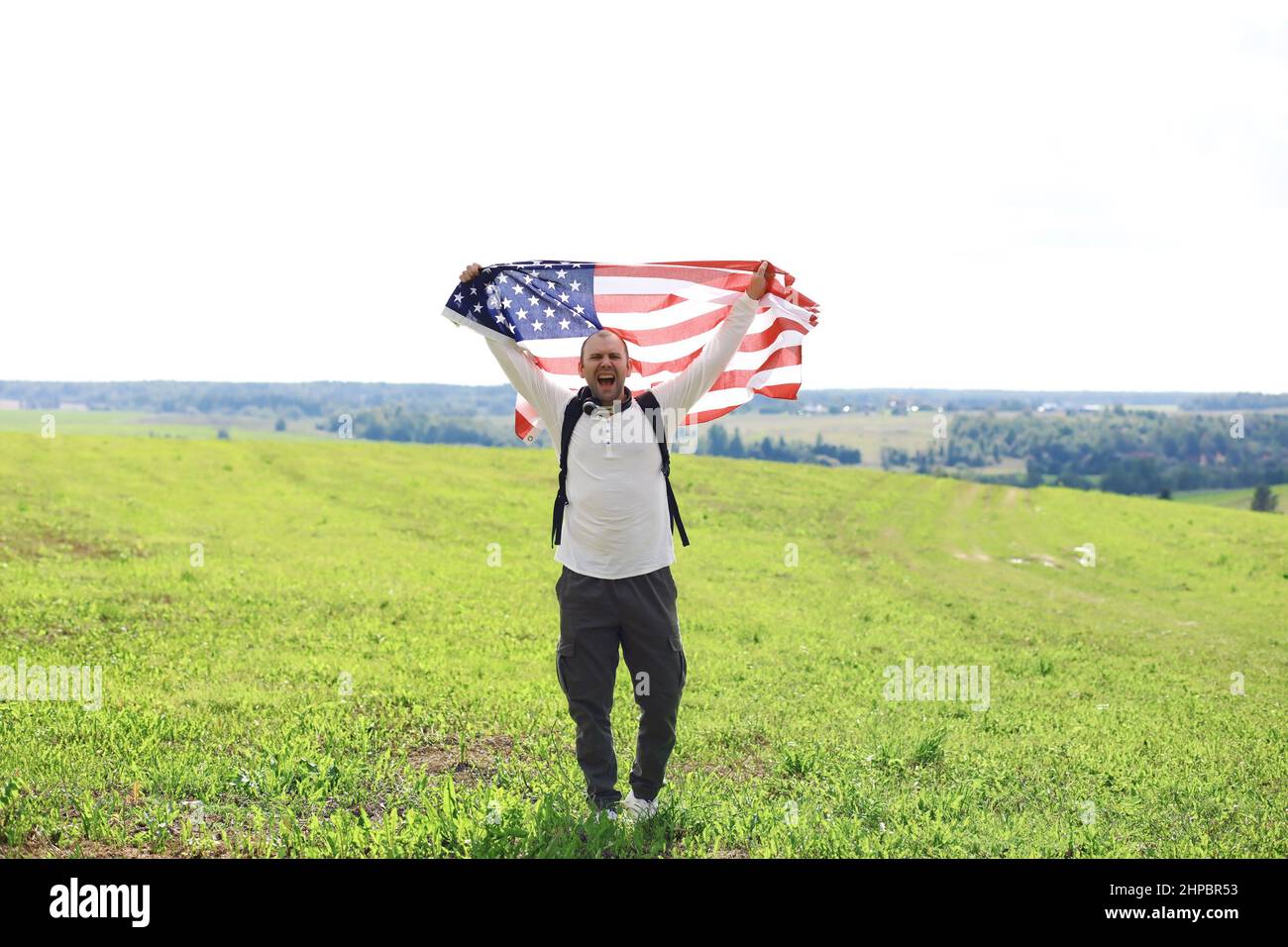 Man waving American flag standing in farm agricultural field , holidays ...