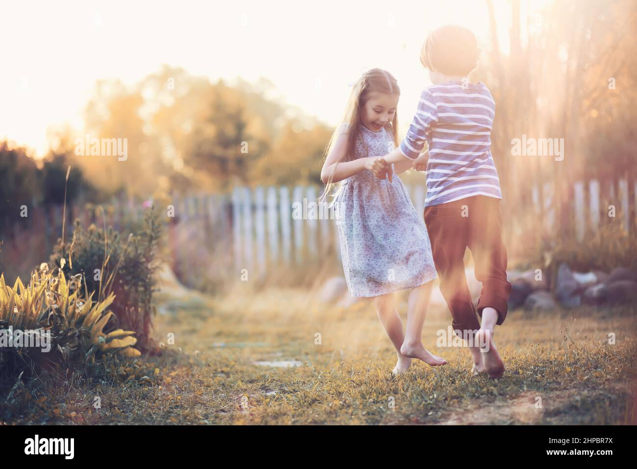 Children walk in the summer in nature. Child on a sunny spring morning ...