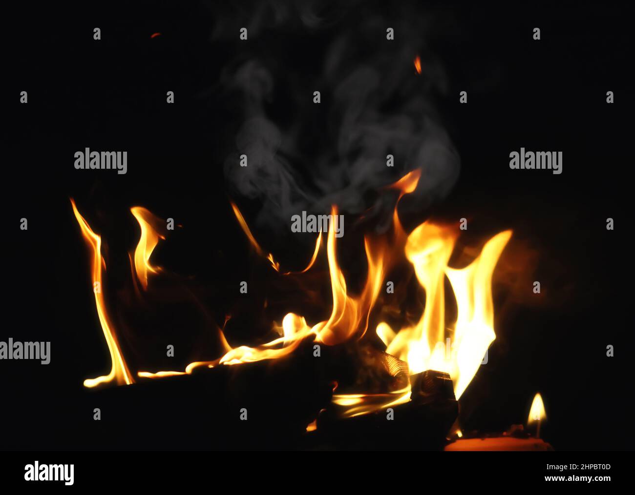 The flames of burning wood in the fireplace of a country house. Coals ...