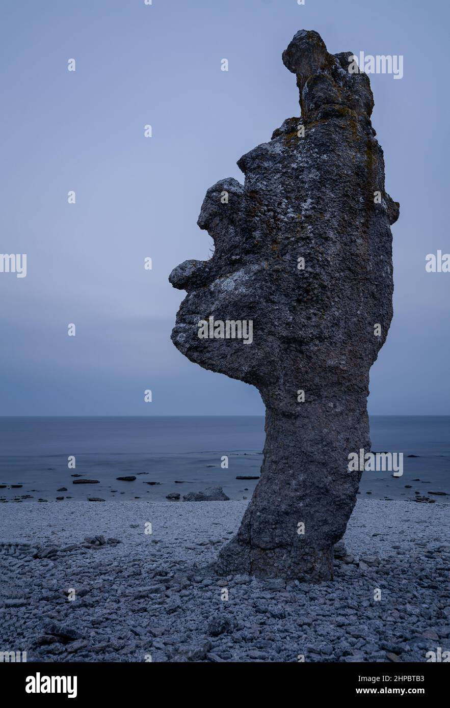 A tall rock formation resembling a face on a beach at Langhammers ...