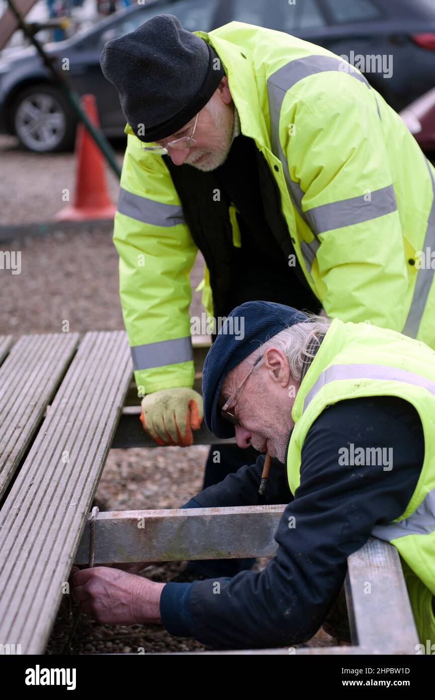 two men working together at sailing club marina Stock Photo - Alamy