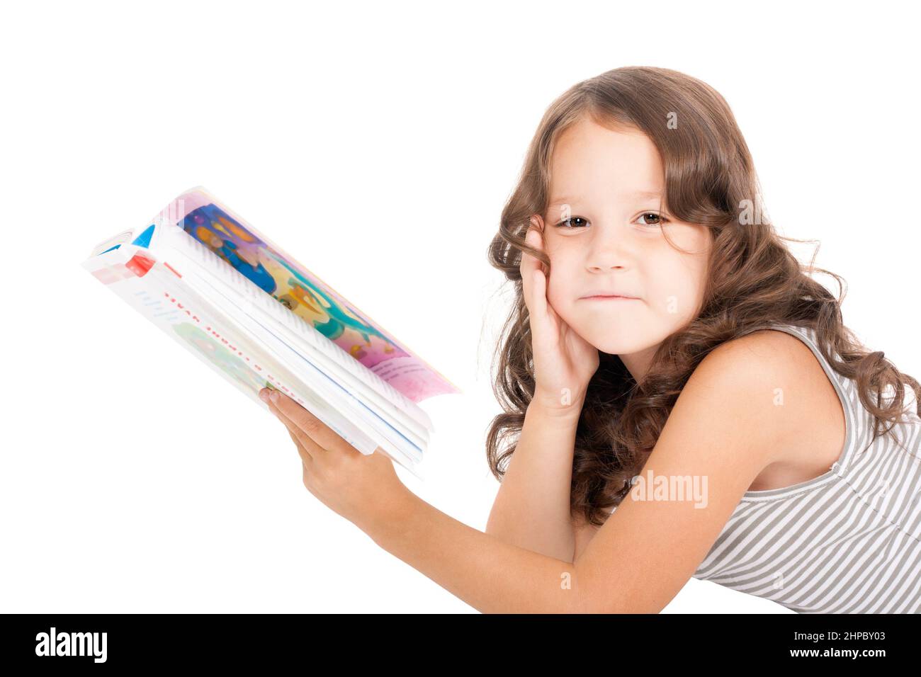 Pretty little girl reading a book on the floor Stock Photo - Alamy