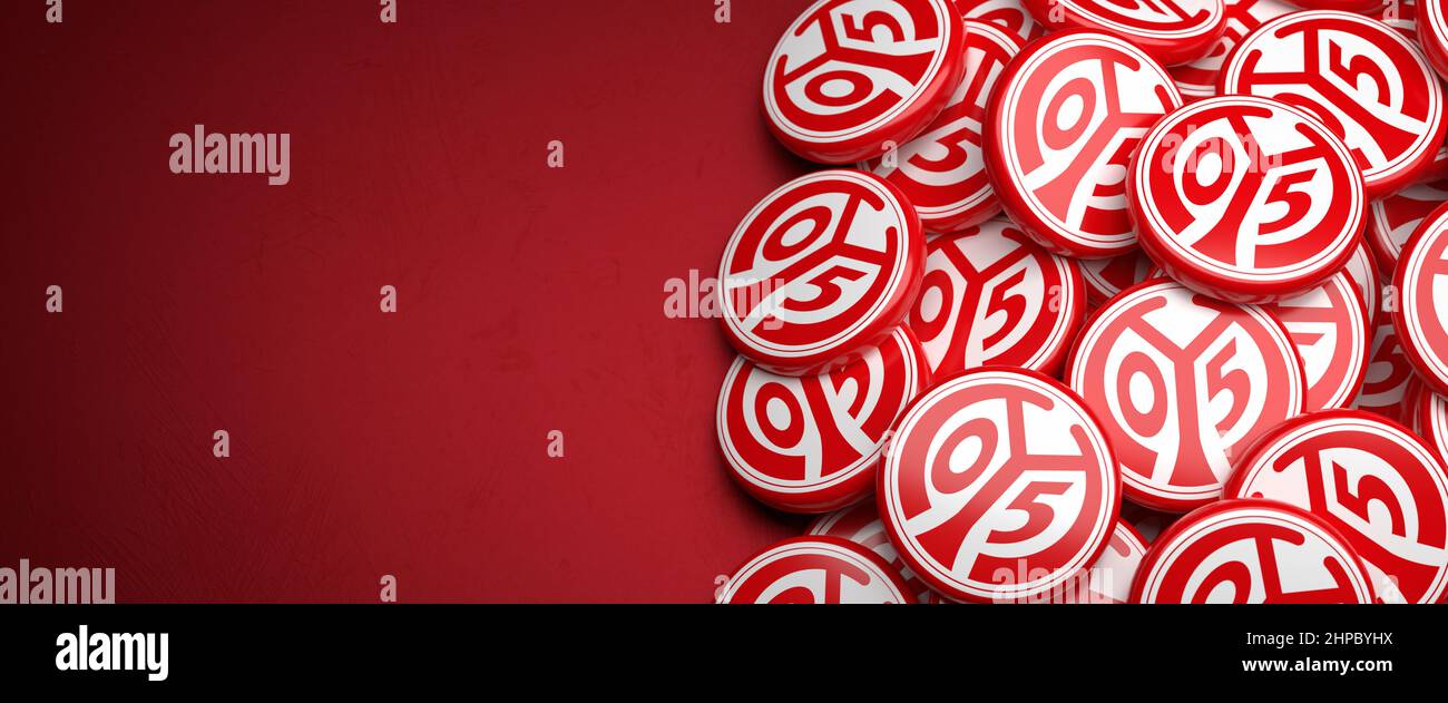 Logos of the German Soccer Club FSV Mainz 05 on a heap on a table. Copy ...