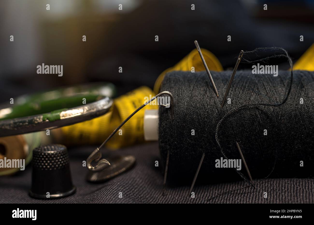 Old retro tailor's tools for sewing clothes. Centimeter, scissors ...
