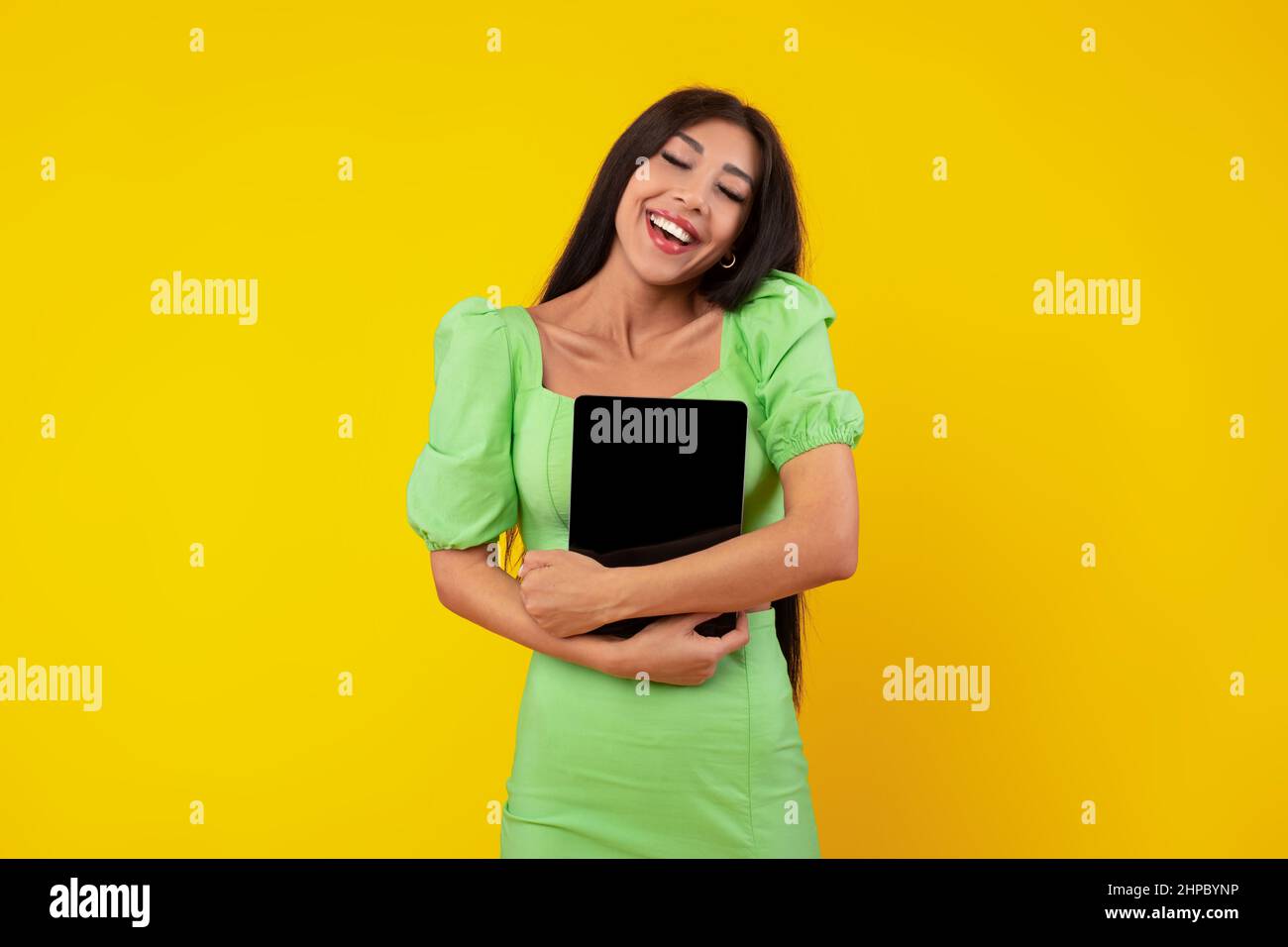 Technology Lover. Excited woman hugging digital tablet Stock Photo - Alamy