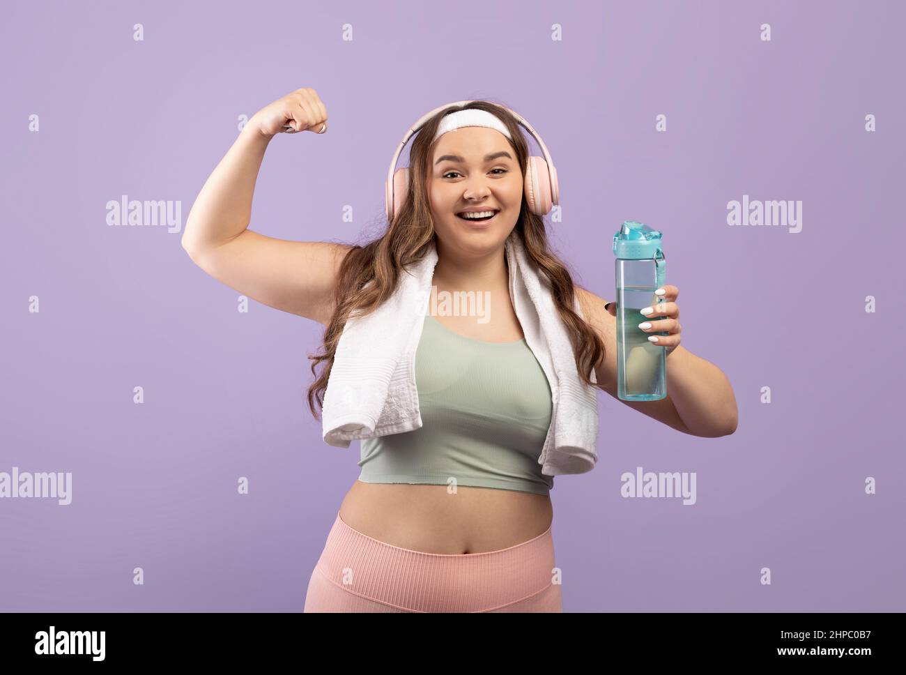 Young woman shows biceps hi-res stock photography and images - Alamy
