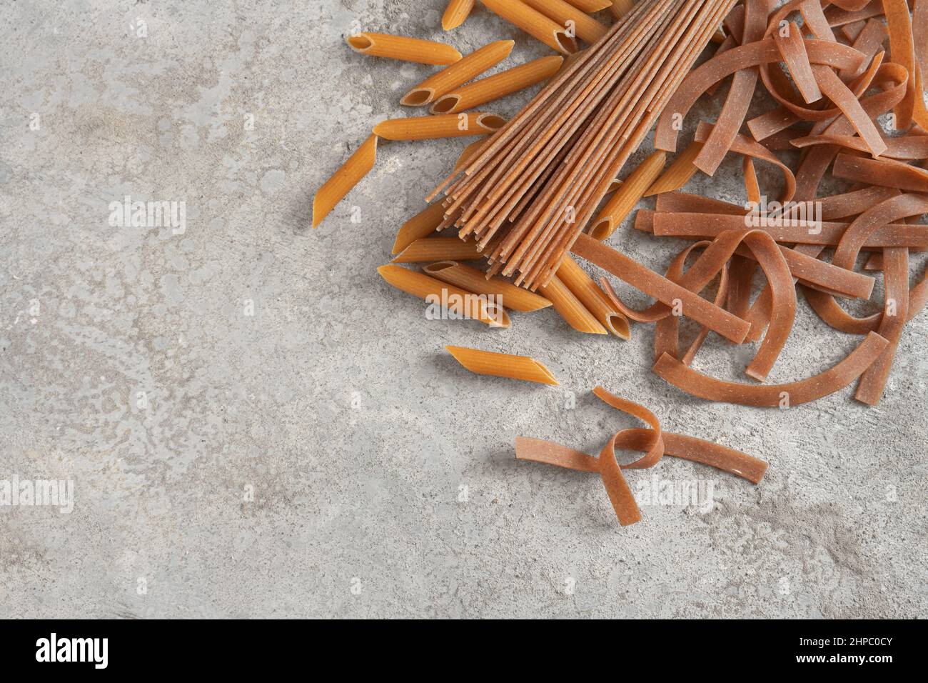 Different types of wholegrain pasta, tagliatelle, and penne rigate, on ...