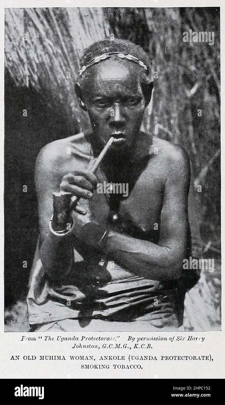 an old Muhima woman, Ankole (Uganda pbotectorate), smoking tobacco ...
