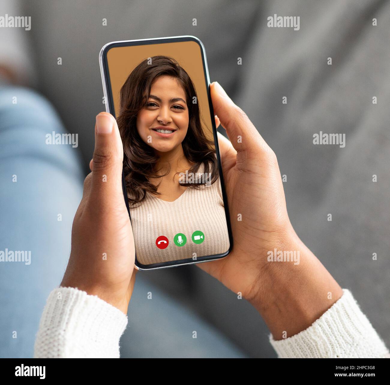 Young woman communicating with her female friend online via video call ...