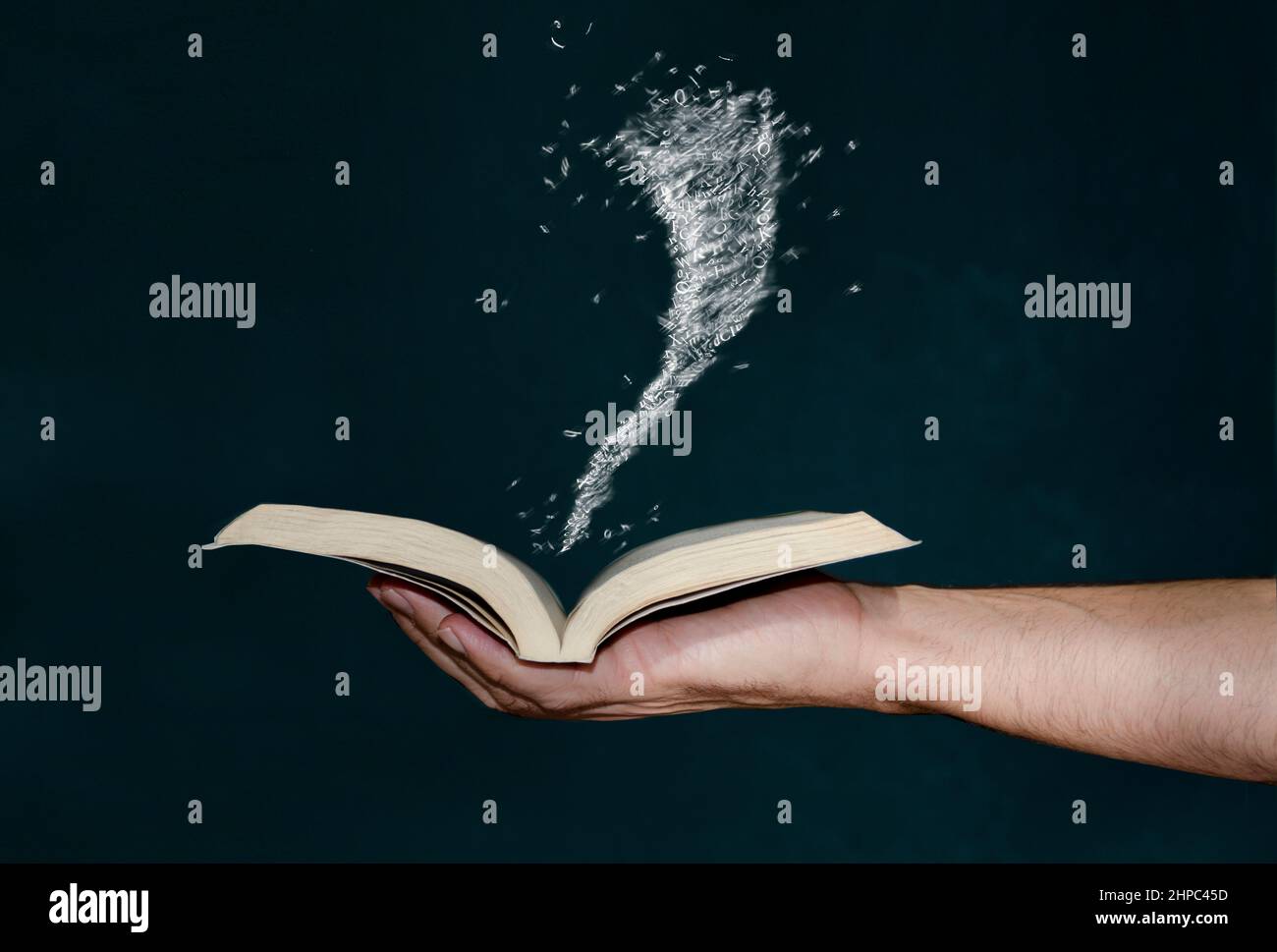Man holding magic book with hand Stock Photo - Alamy