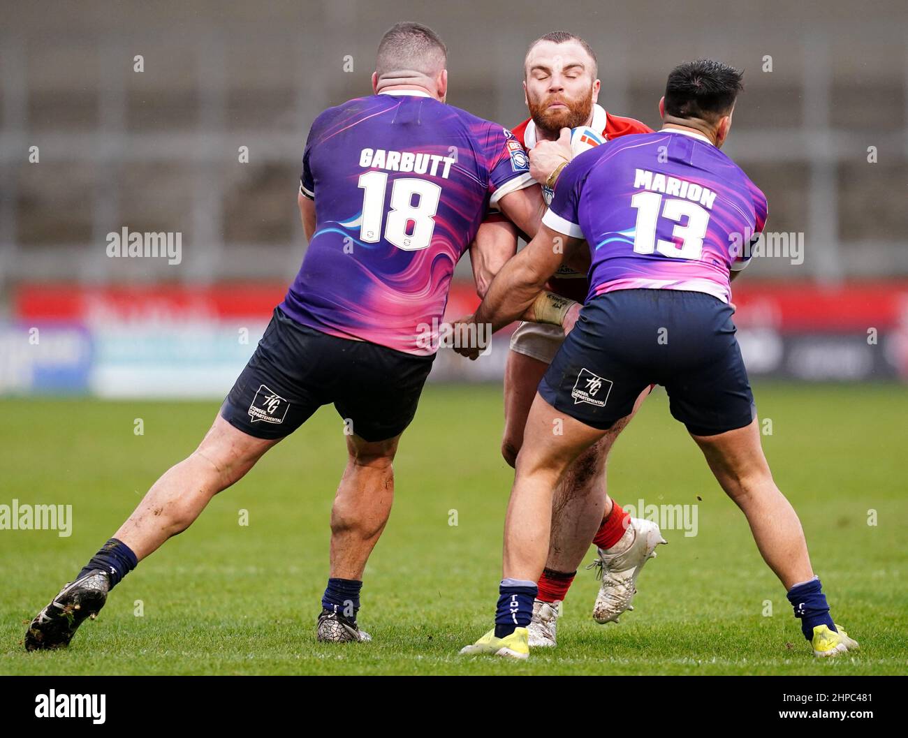 Salford Red Devils' Greg Burke (centre) tackled by Toulouse Olympique's ...