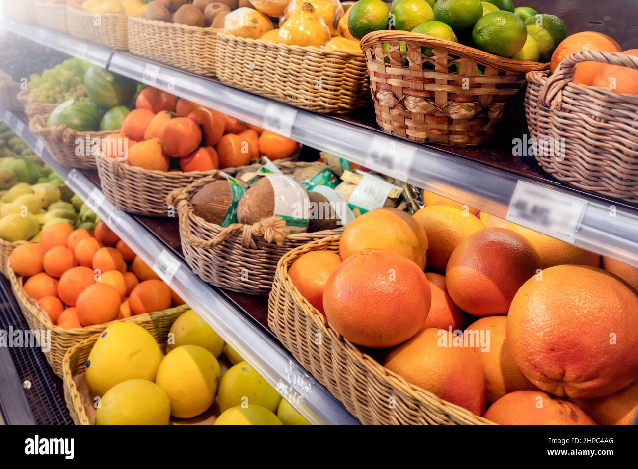 showcase with fresh fruits in the grocery store, healthy food and ...
