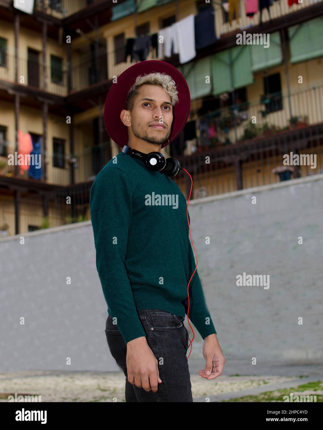 Young man with headphones and red hat in hand in the city Stock Photo ...