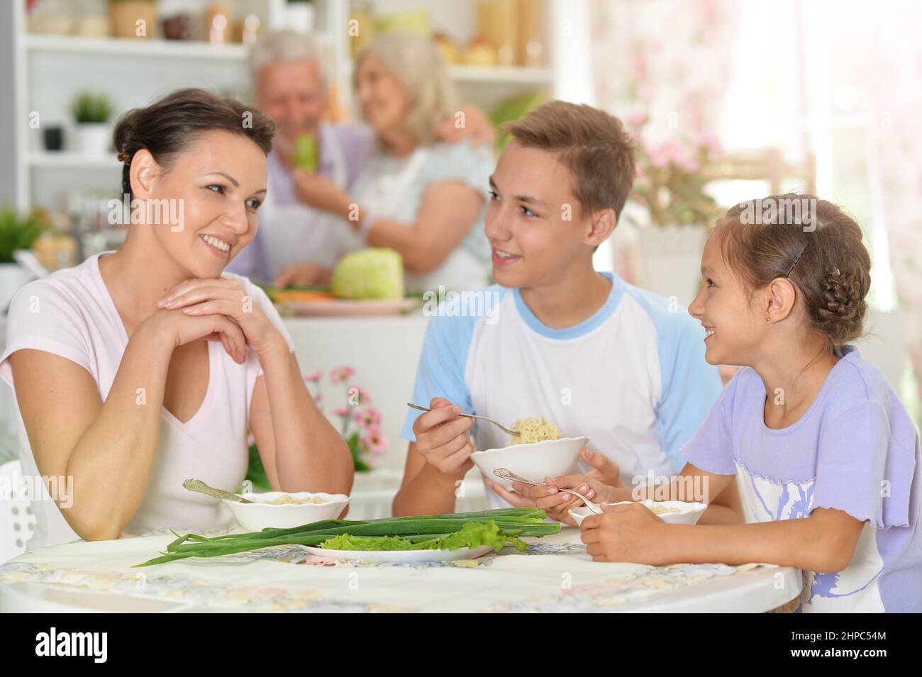 Portrait of family eating tasty breakfast at home Stock Photo - Alamy