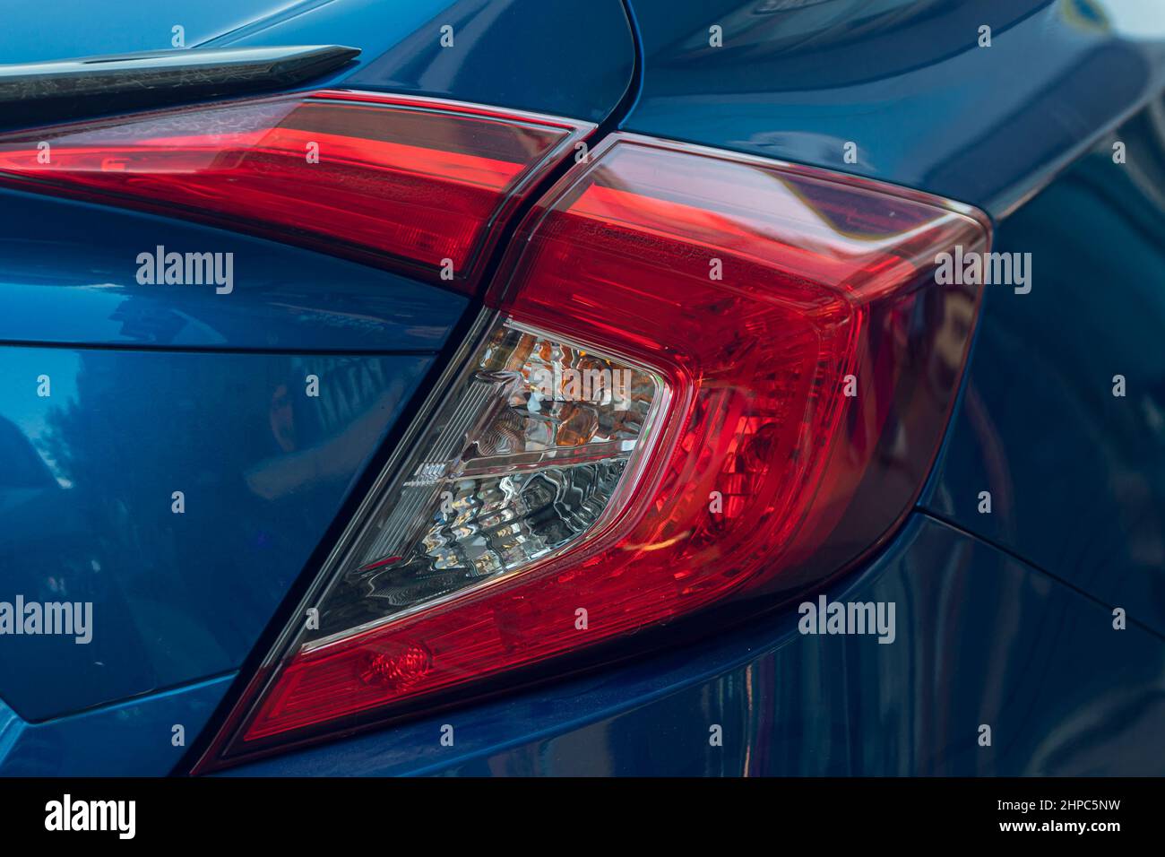 Macro view of modern blue car xenon lamp taillight, bumper, rear trunk ...