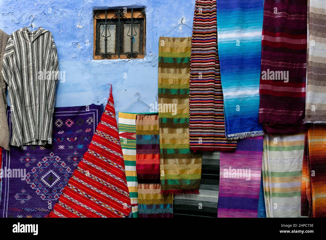 Rugs and djeelaba hung outside a shop in Chefchaouen Stock Photo - Alamy
