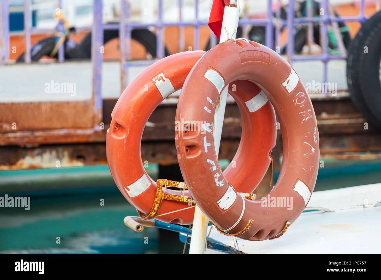 close-up lifebuoy on a boat. Red lifebuoy on ship railing with sea ...