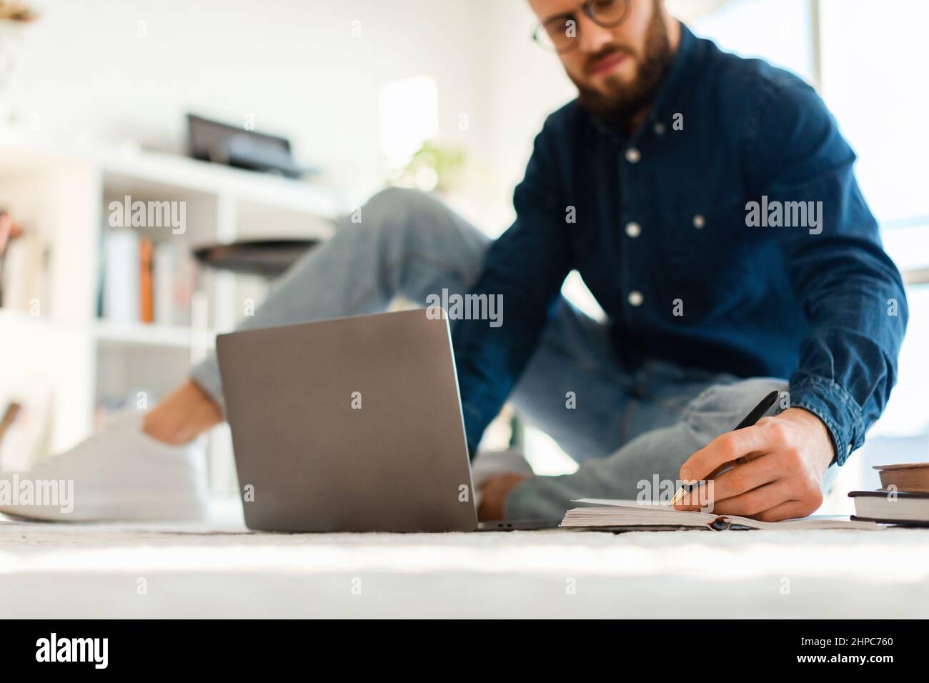 Man Taking Notes Using Laptop Sitting On Floor Indoors, Cropped Stock ...