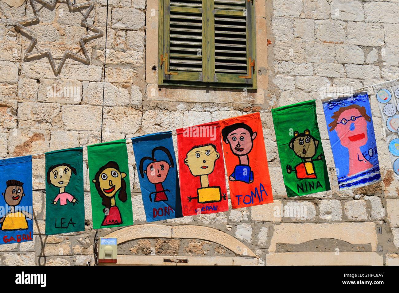 Funny flags on narrow vintage street of European city. Pennants and ...