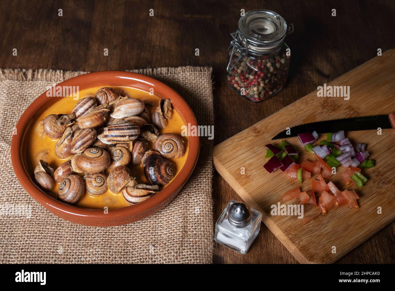 Snail stew, dish based on a sauce of vegetables and cooked snails Stock ...