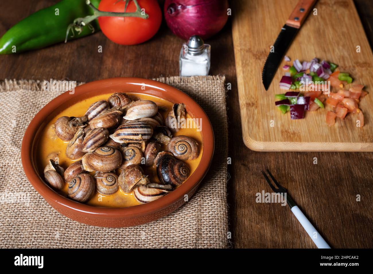 Snail stew, dish based on a sauce of vegetables and cooked snails Stock ...