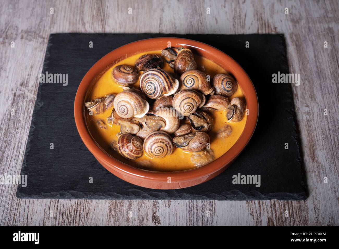 Snail stew, dish based on a sauce of vegetables and cooked snails Stock ...