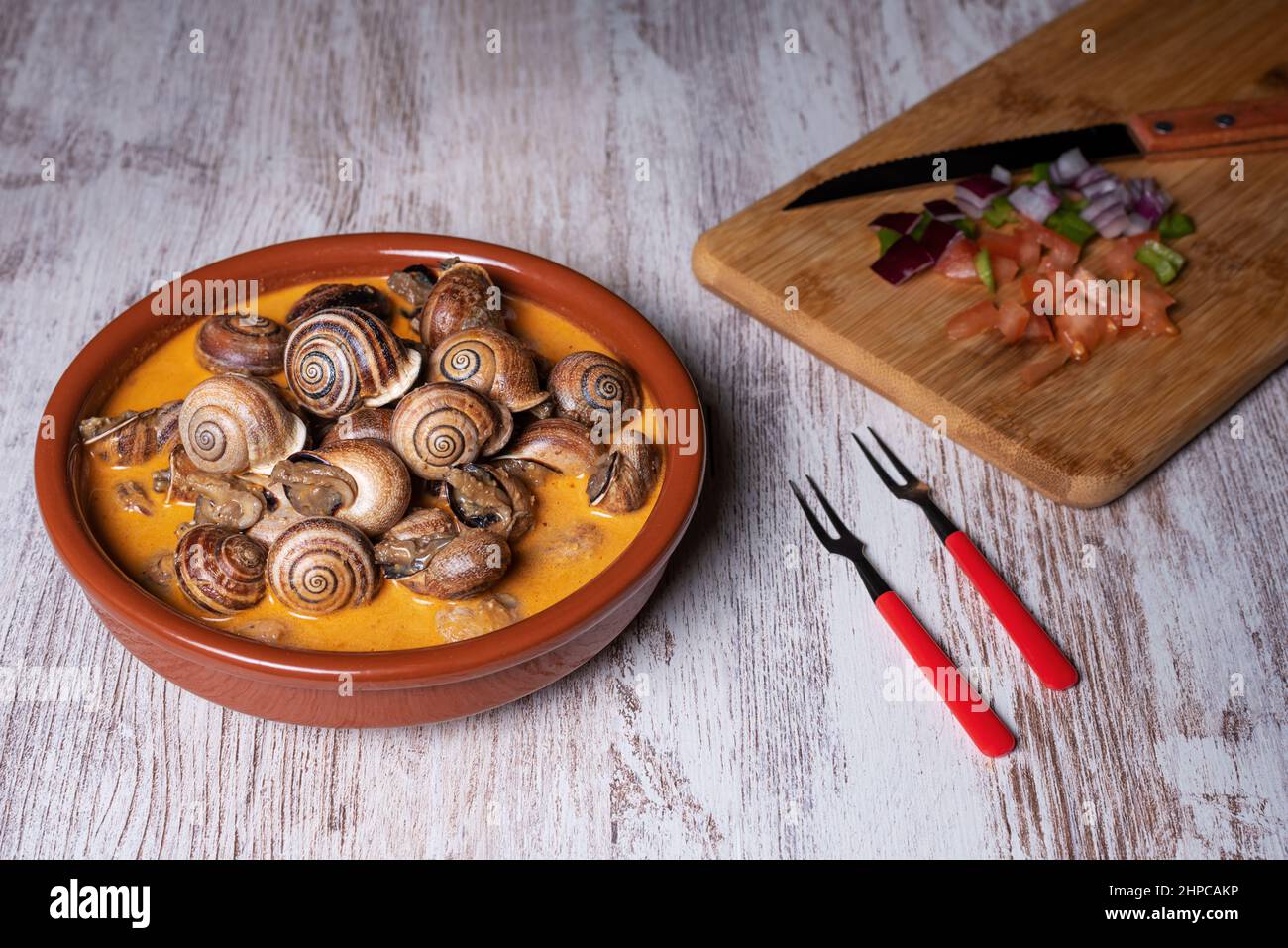 Snail stew, dish based on a sauce of vegetables and cooked snails Stock ...