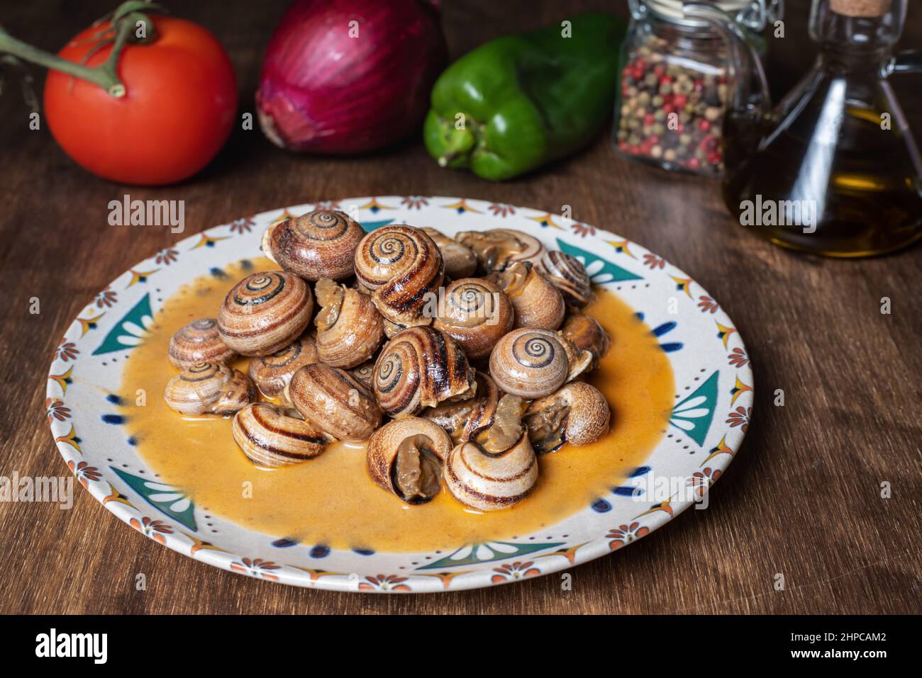 Snail stew, dish based on a sauce of vegetables and cooked snails Stock ...