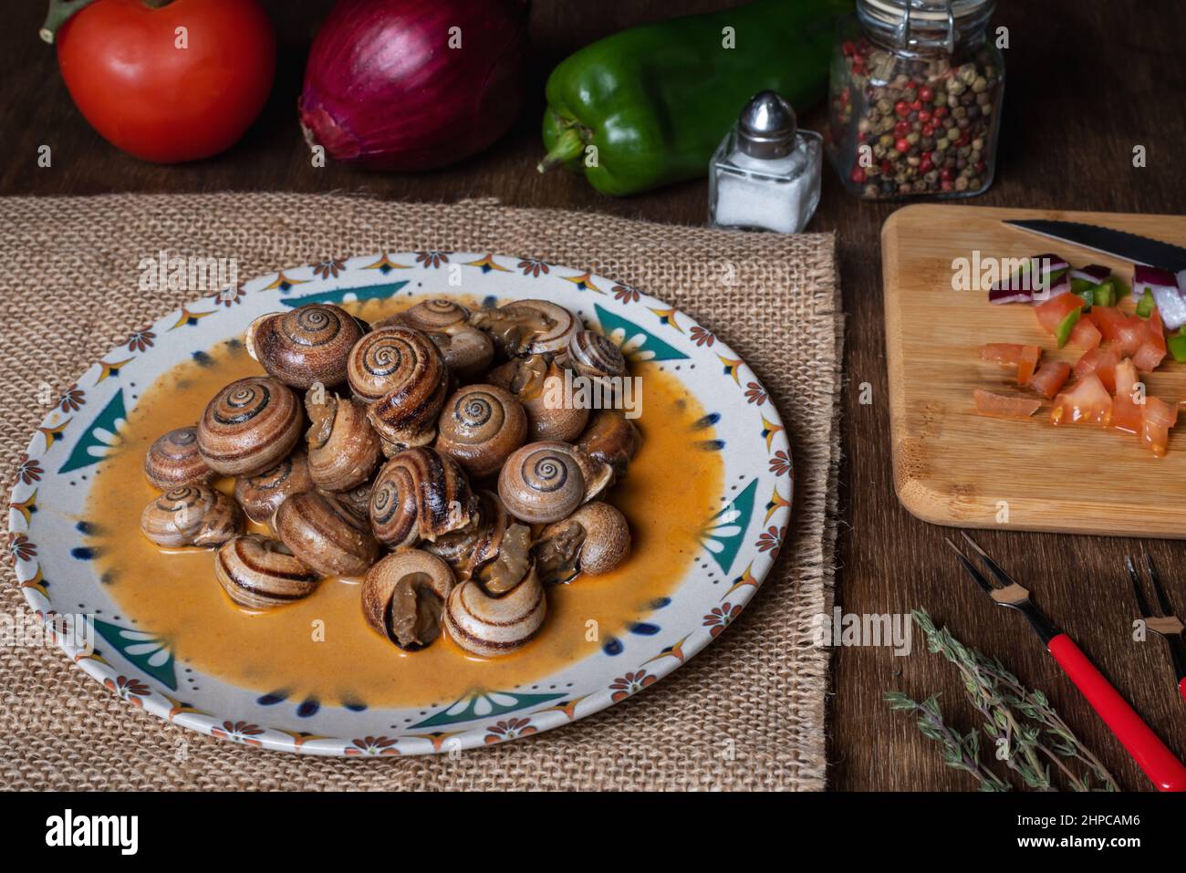 Snail stew, dish based on a sauce of vegetables and cooked snails Stock ...