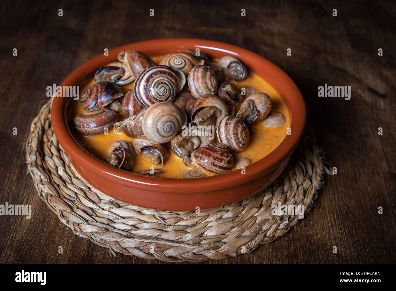 Snail stew, dish based on a sauce of vegetables and cooked snails Stock ...