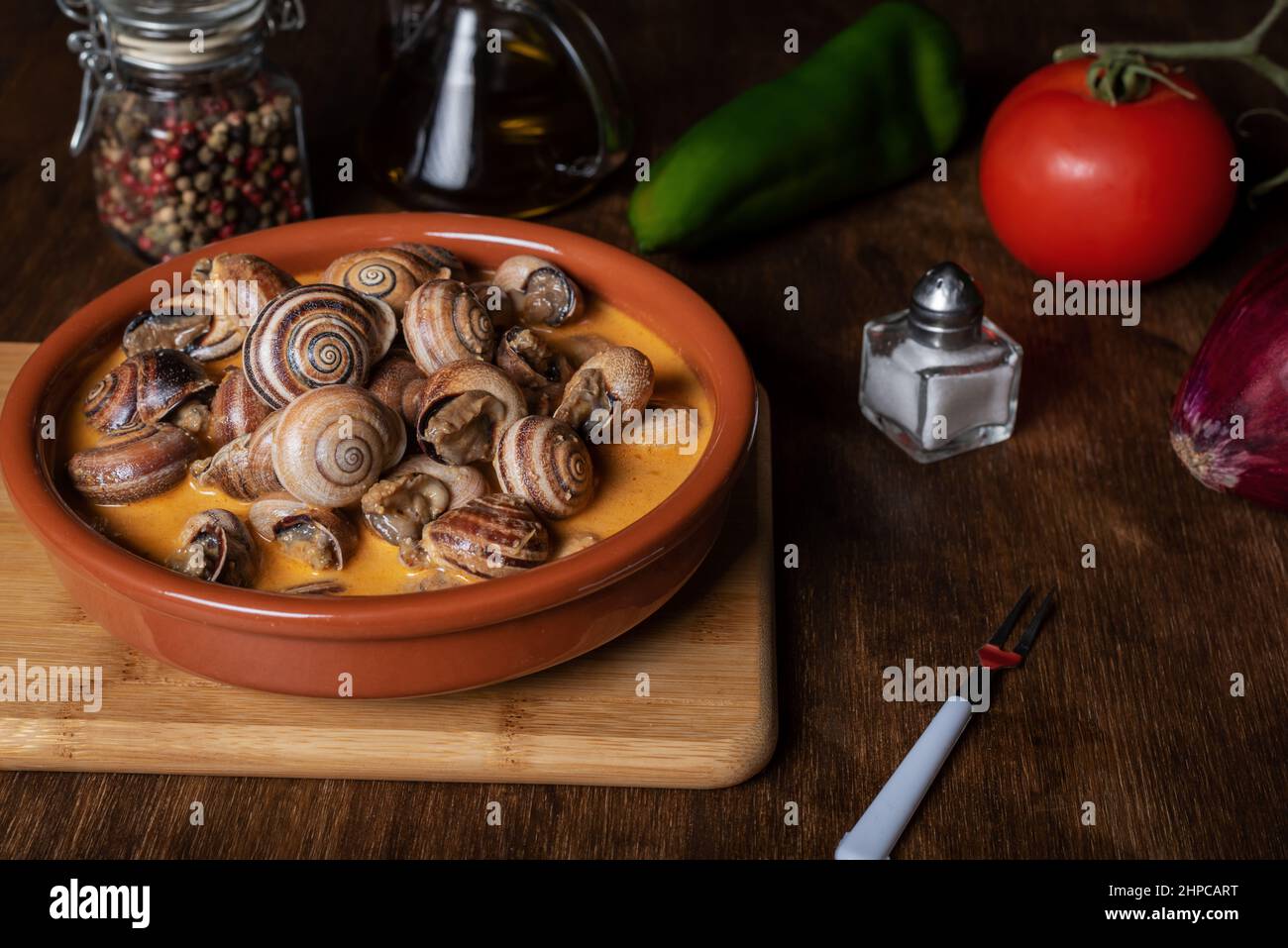 Snail stew, dish based on a sauce of vegetables and cooked snails Stock ...