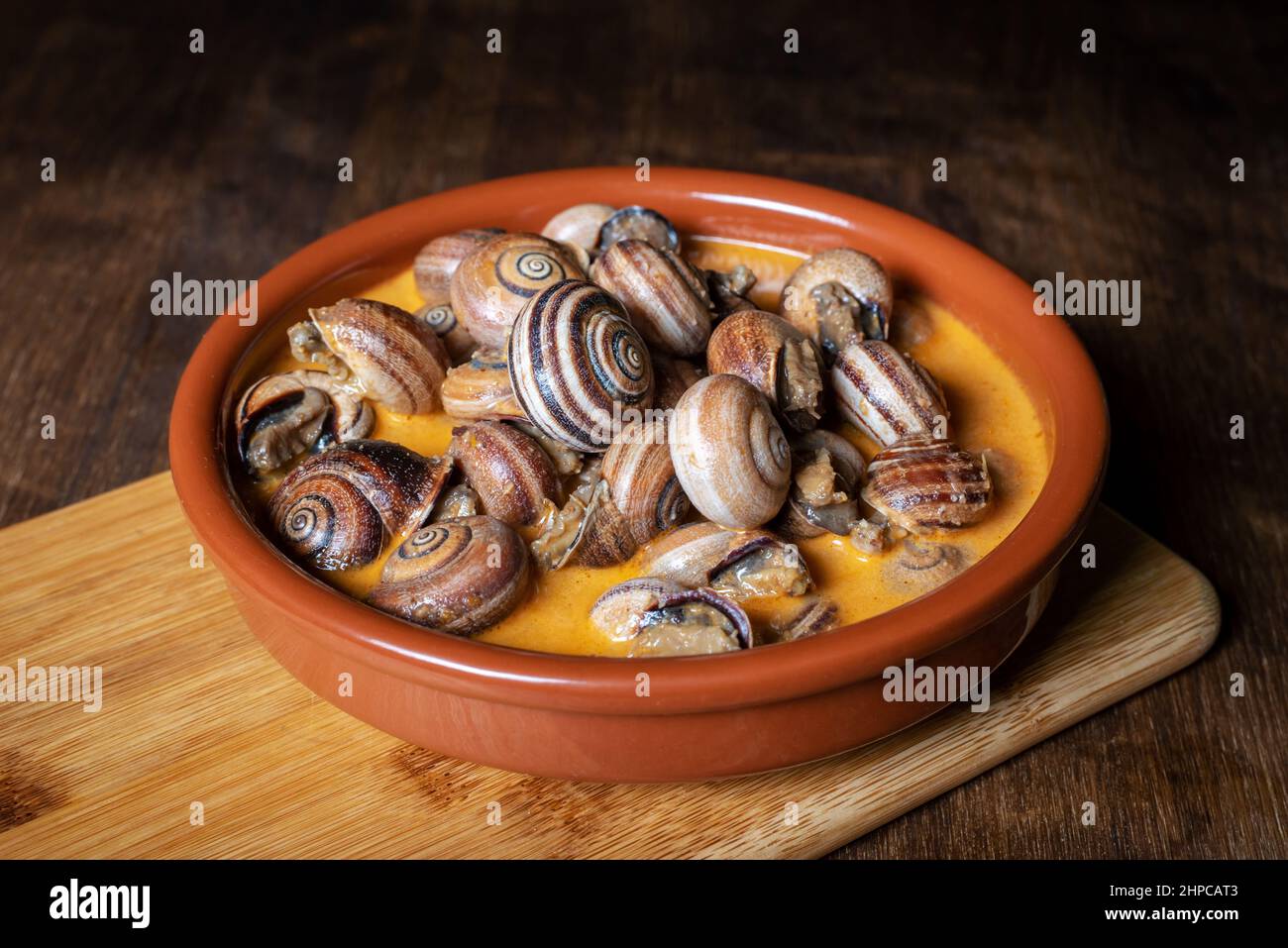 Snail stew, dish based on a sauce of vegetables and cooked snails Stock ...