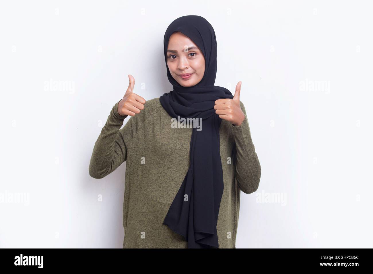 young asian beautiful muslim woman with ok sign gesture tumb up isolated on white background ...
