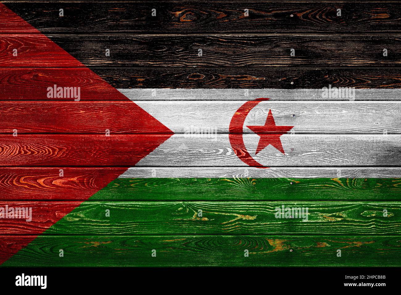 The national flag of West Sahara is painted on a camp of even boards ...