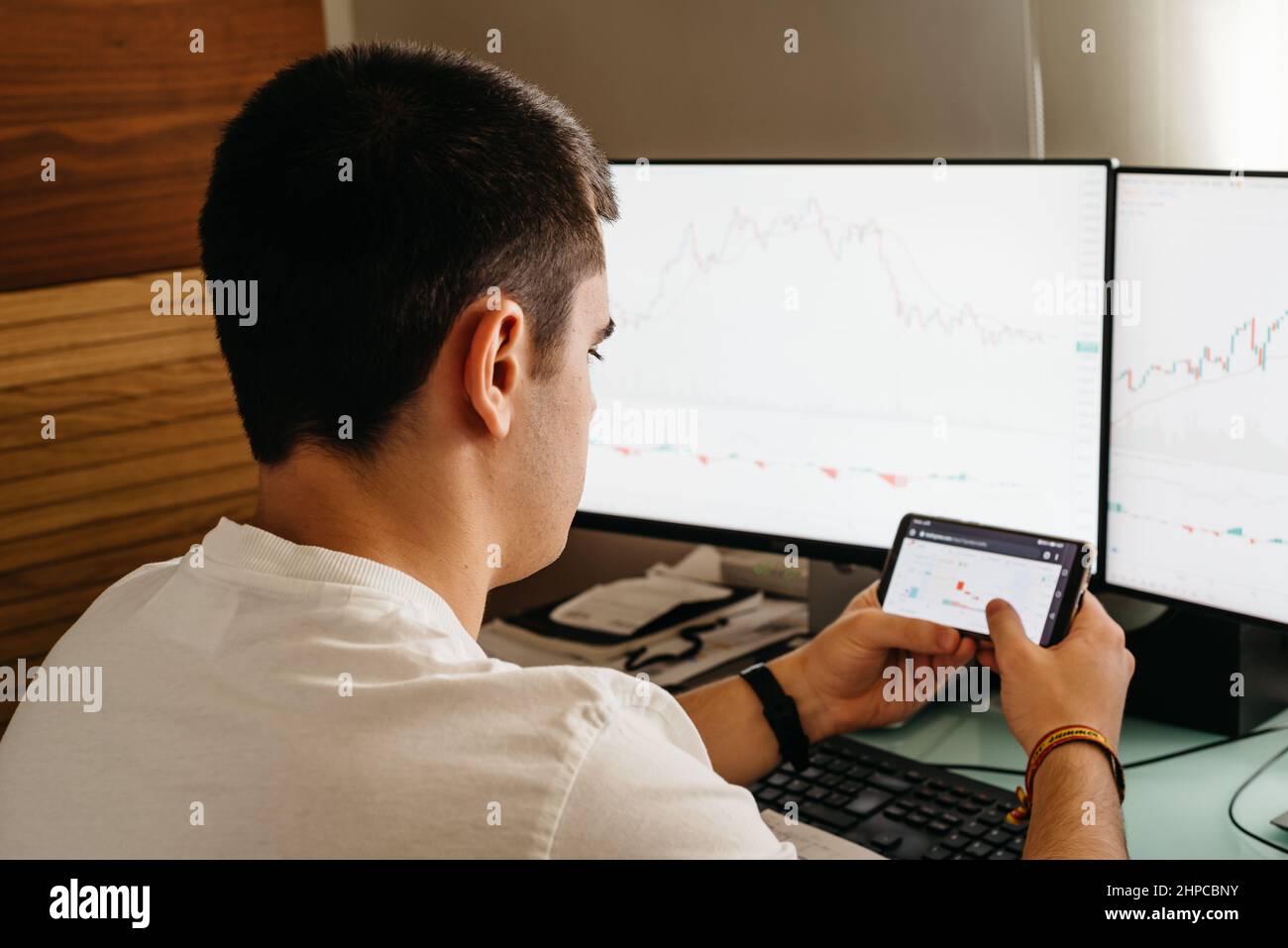 Busy working day at home. Side view of successful young trader in ...